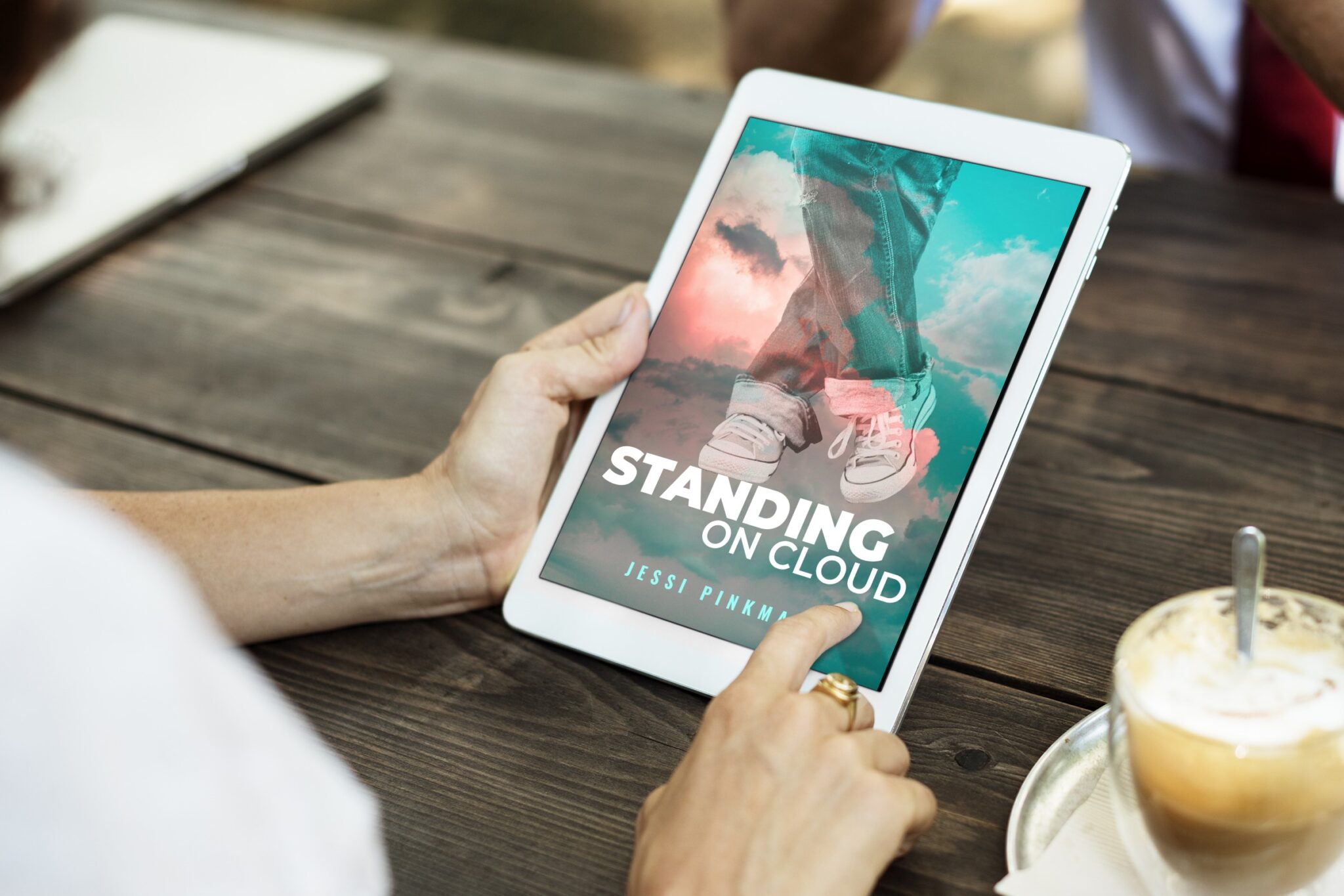 Book Design in an Ipad on top of a wooden table | Mediamodifier